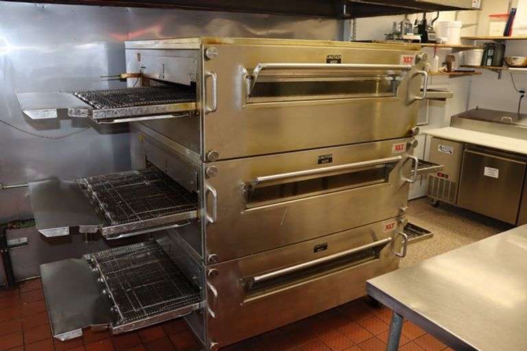 Triple stack of XLT model 3255C-S1248 gas conveyor pizza ovens - 1 ...