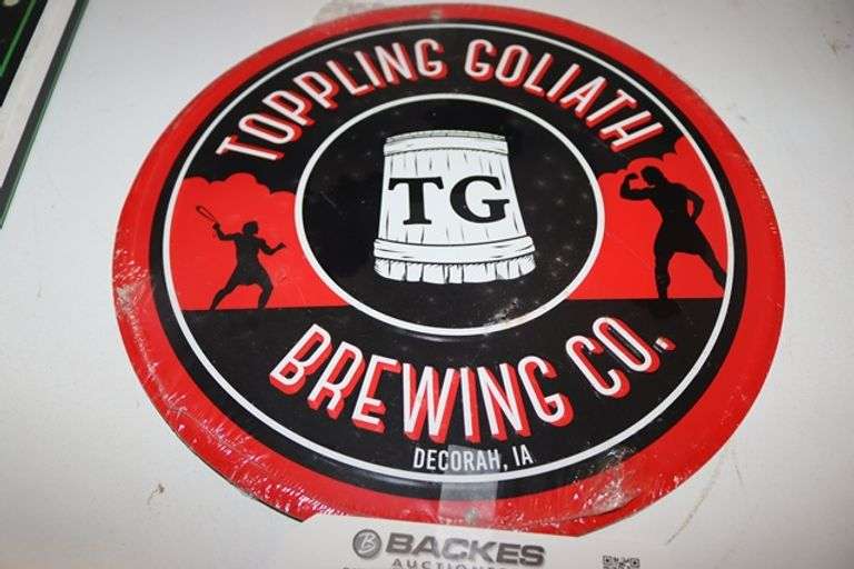 12" Round Topping Goliath metal sign - Backes Commercial Auctioneers