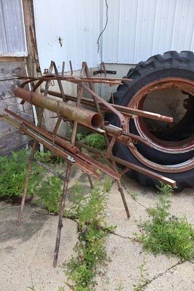 A frame metal stand with some metal scraps - Backes Commercial Auctioneers